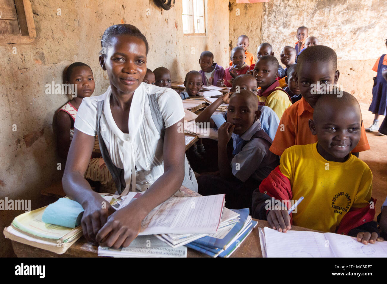 Uganda. June 13 2017. Smiling Ugandan children sitting at desks in a ...