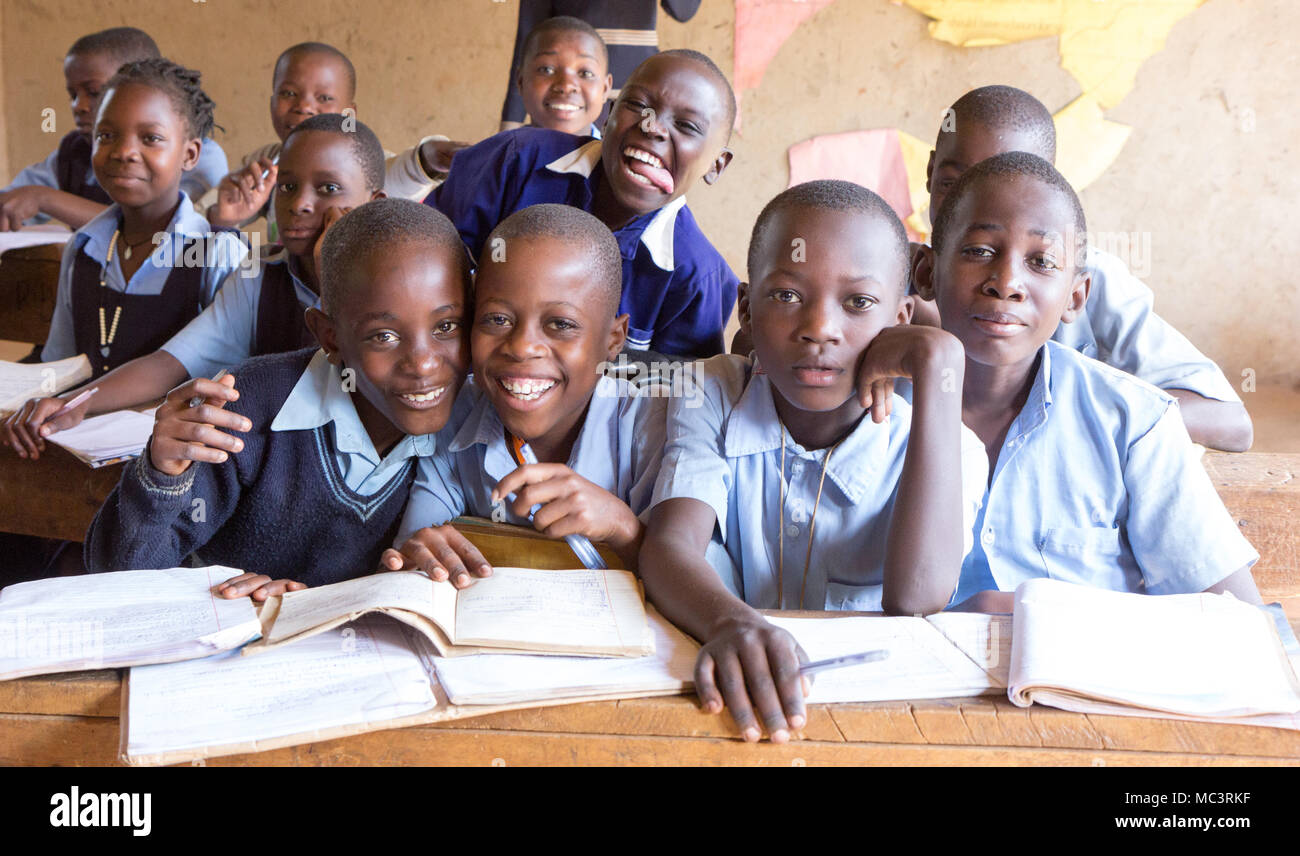 Uganda. June 13 2017. Smiling Ugandan children sitting at desks in a ...