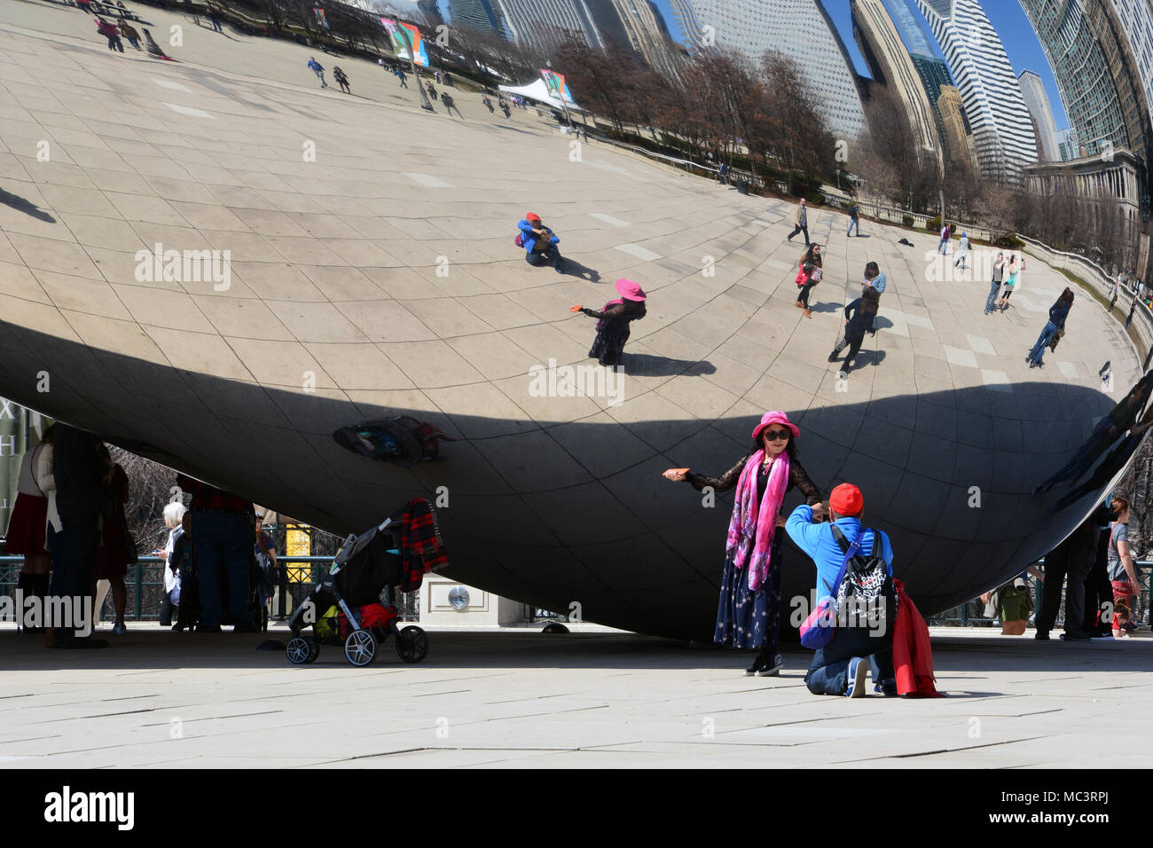A woman playfully poses for selfies with Chicago's "Bean" in Millennium ...