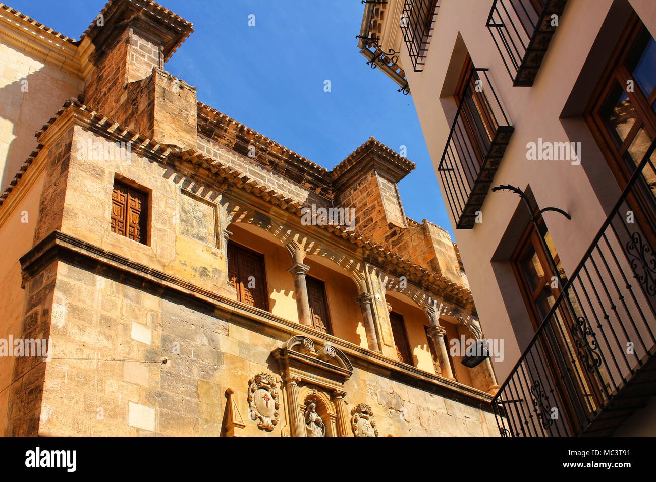 Old facades and El Salvador Church under blue sky in spring in Caravaca ...