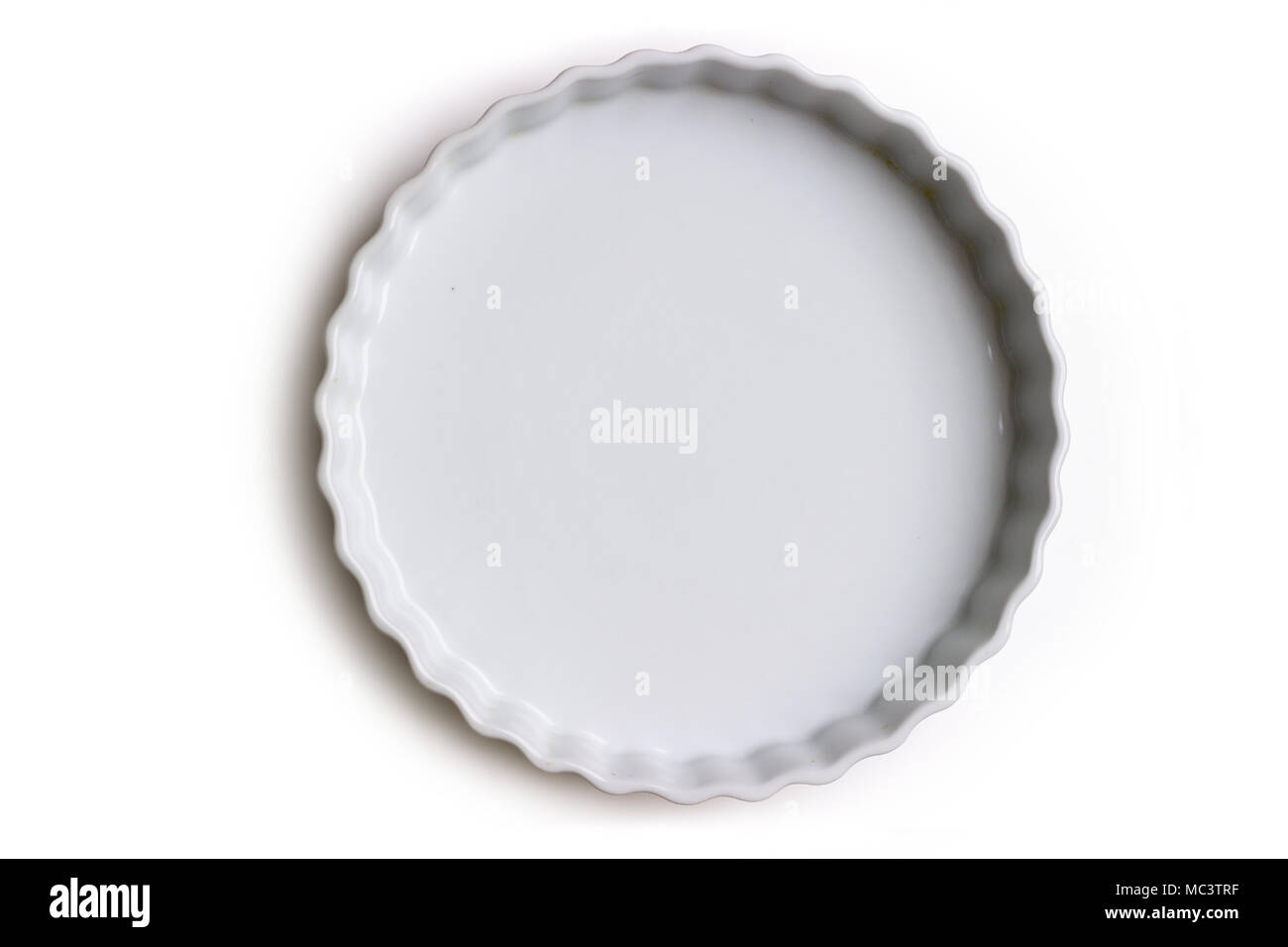 Empty ceramic tart or pie dish, on white background; with copy space ...
