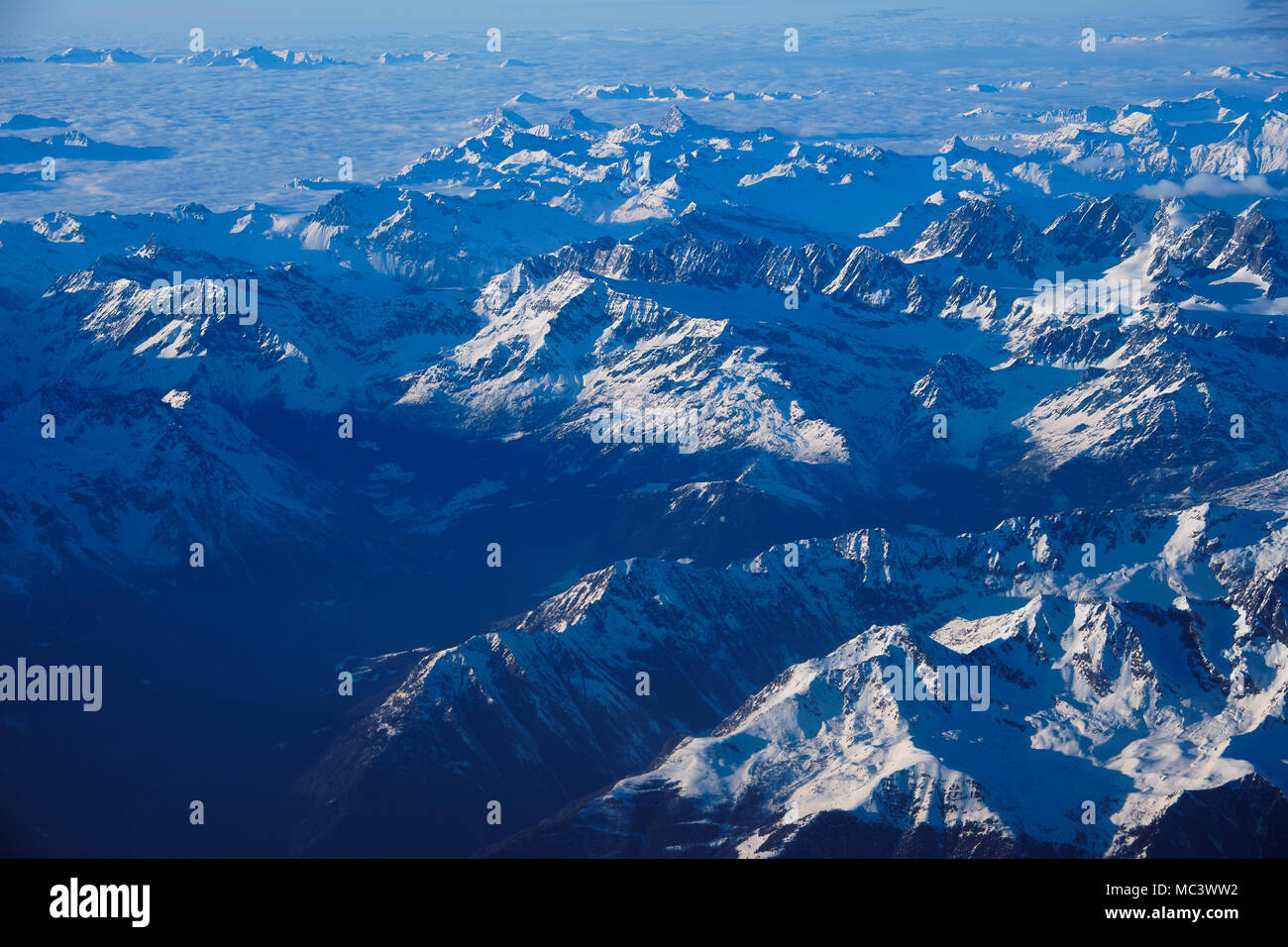 Bird's eye view of mountainscape covered in snow from an airplane Stock ...