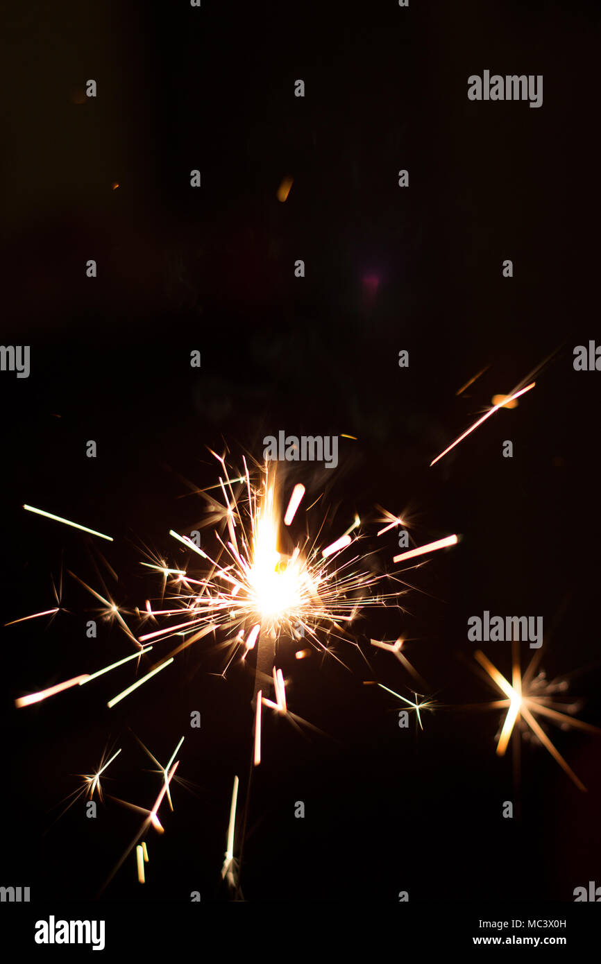 Burning party sparkler on black background Stock Photo - Alamy