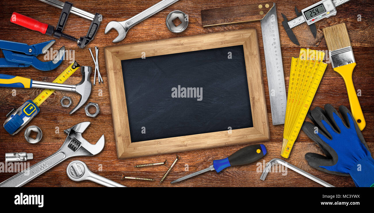 empty copy space blackboard with hand tools on wooden workbench ...
