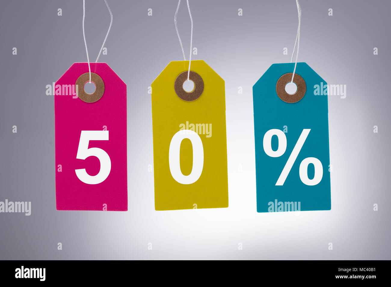 Close-up Of Multi Colored Tags Showing Fifty Percent Against Grey ...