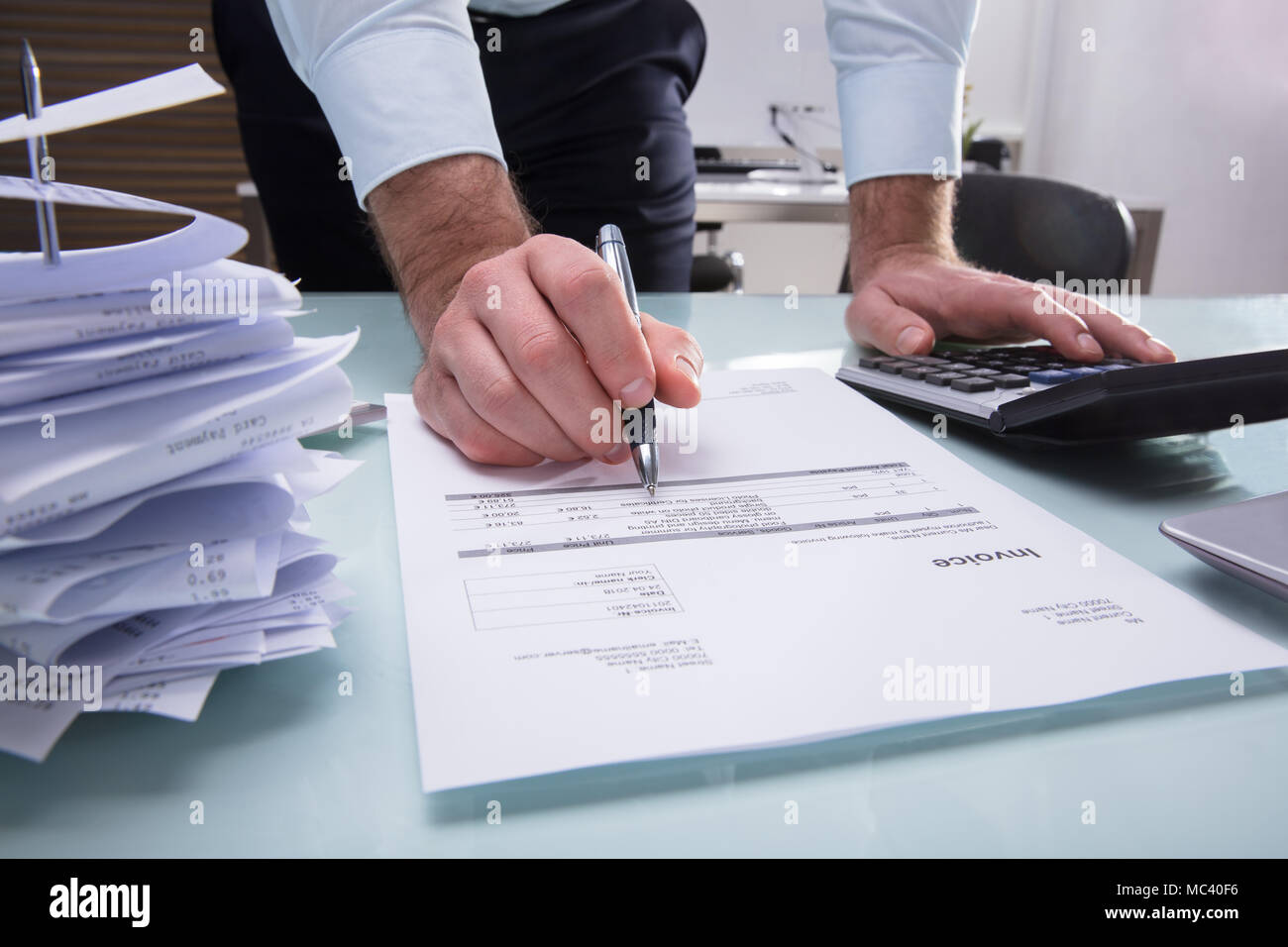 Close-up Of A Human Hand Calculating Invoice At Workplace Stock Photo ...