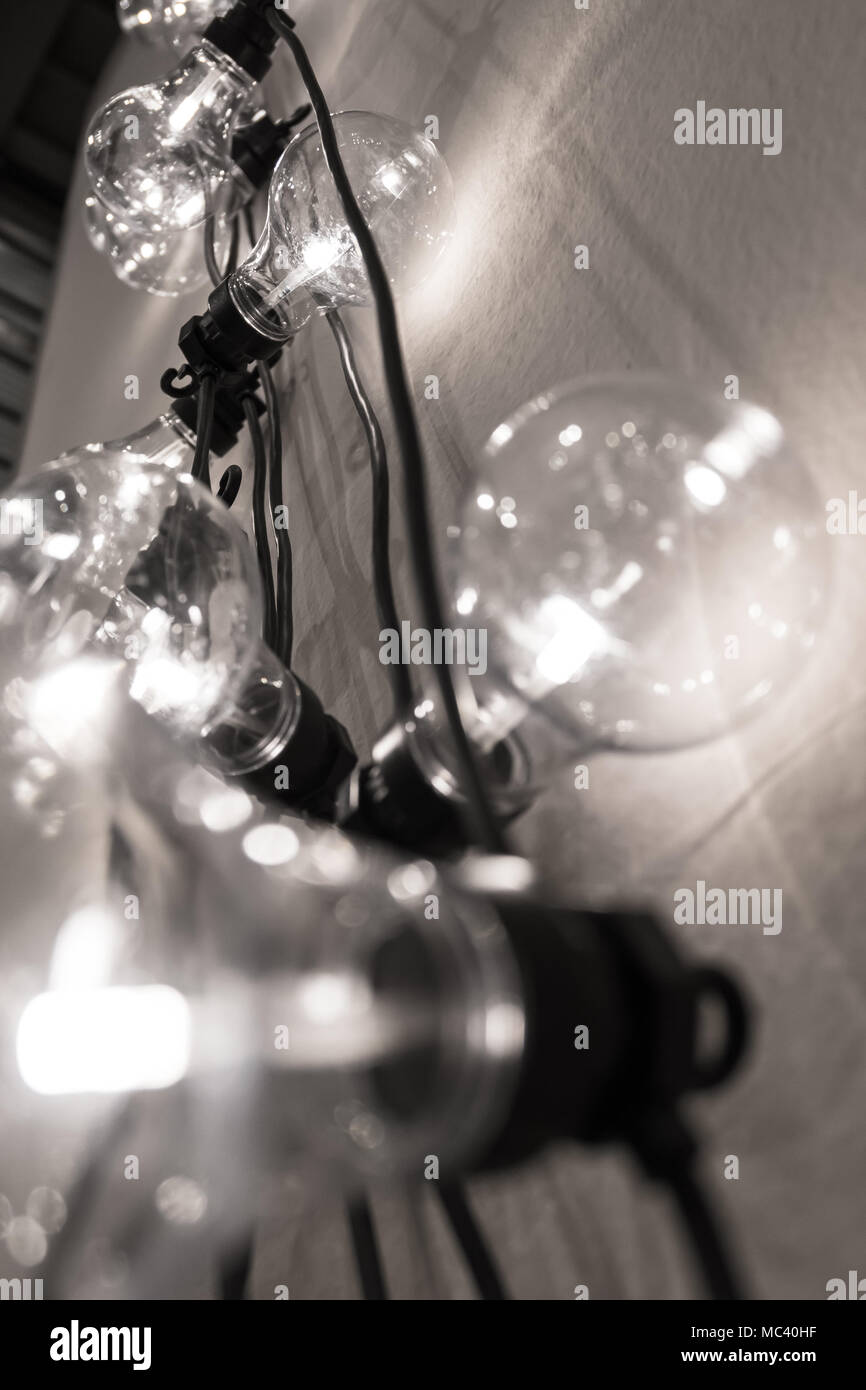 Decorative light bulbs against wall background. Bottom view. Candid ...