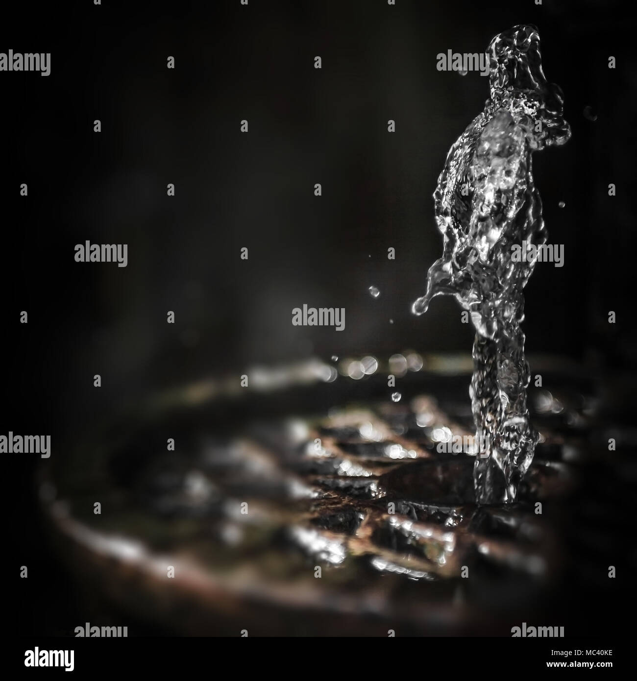 Human figure dancing in splash of water in the fountain on abstract ...