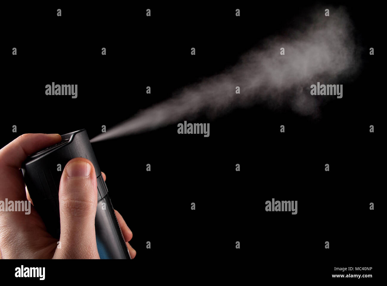 Spray aerosol on black background hi-res stock photography and images ...