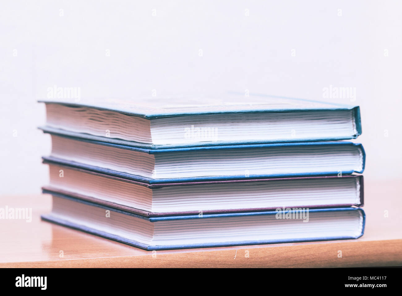 A stack of books on a light background. Four books in a pile Stock ...