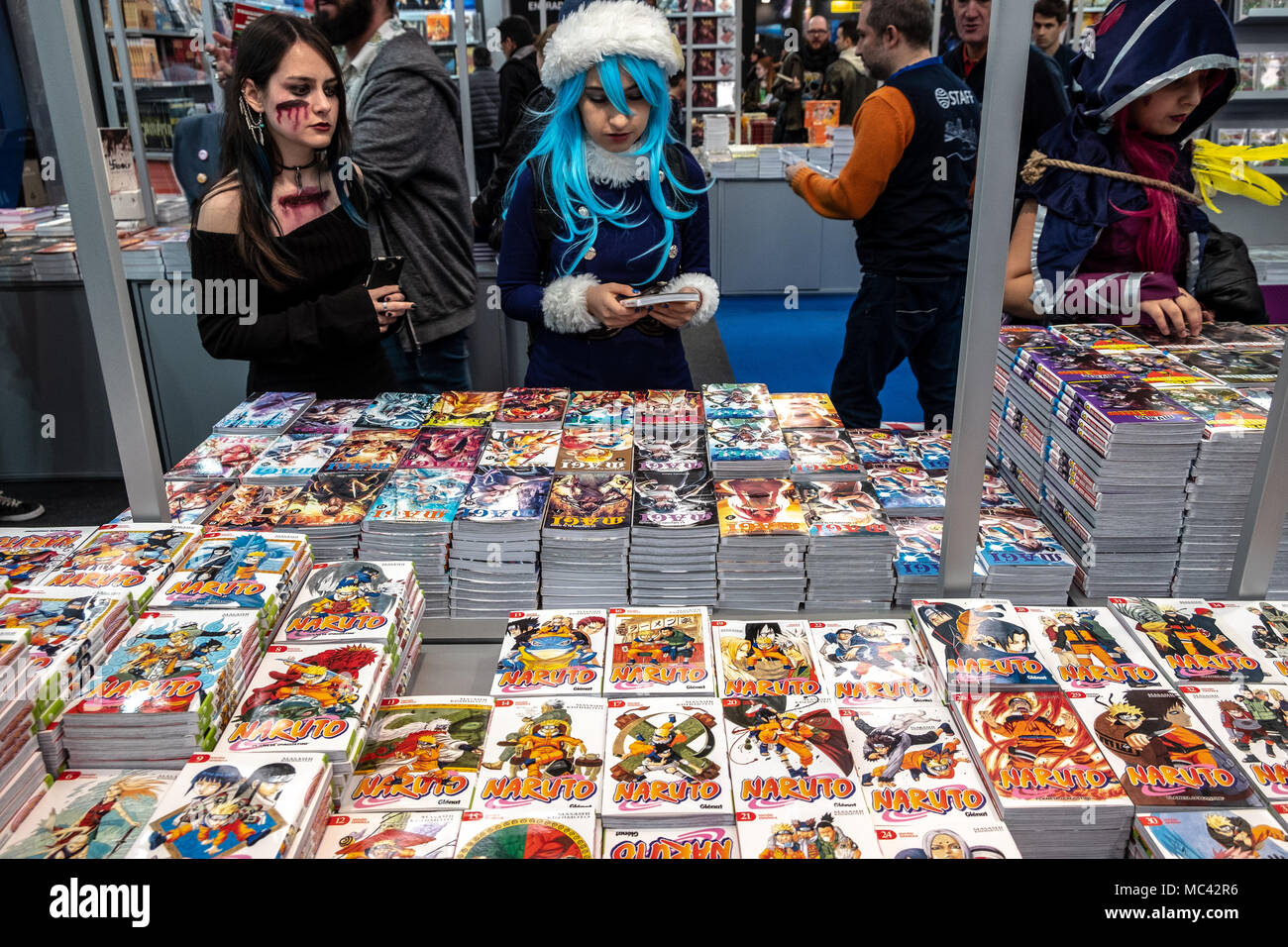 Young girls seen wearing cosplay costumes while selecting Naruto's ...