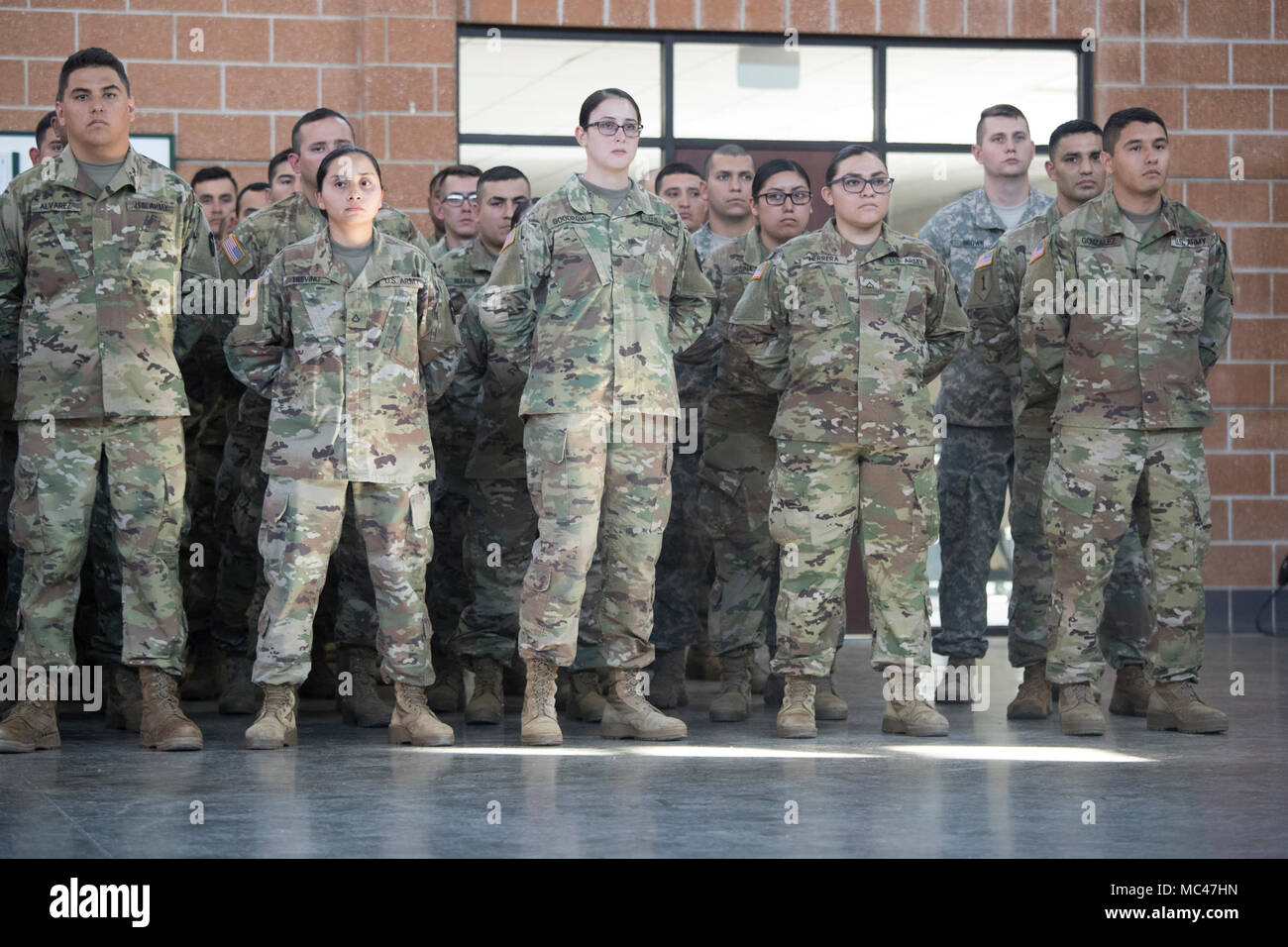 Members of the Texas National Guard stand at attention while hearing a ...