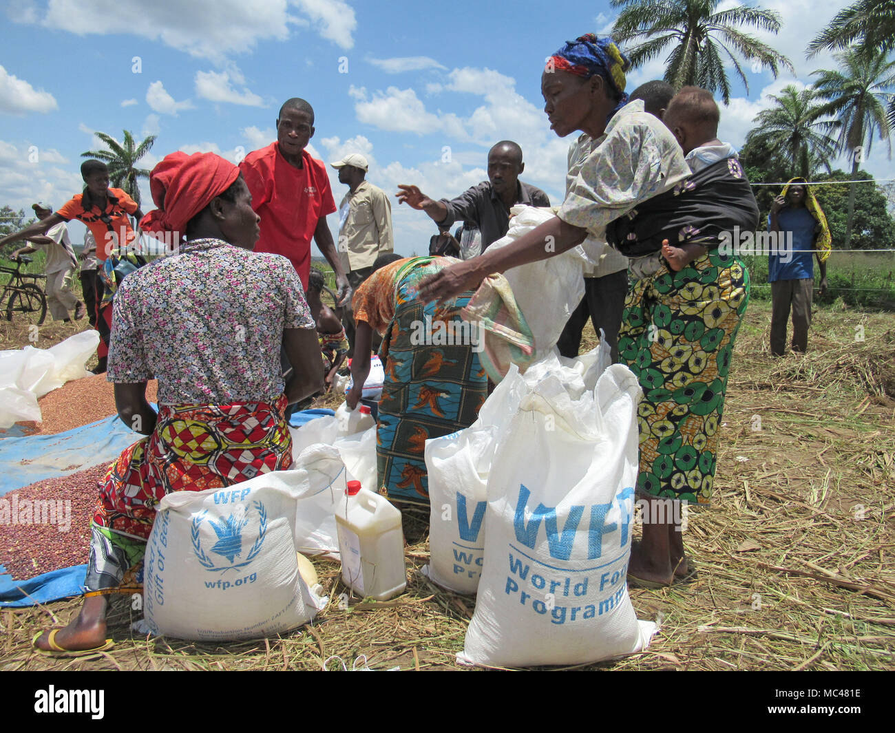 13 March 2018, Congo, Kananga: People share out rations of beans at a ...