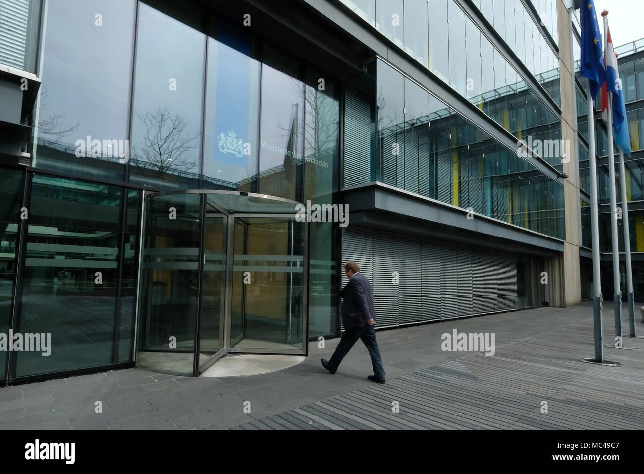 A man walks in to the Finance Ministry building in The Hague ...