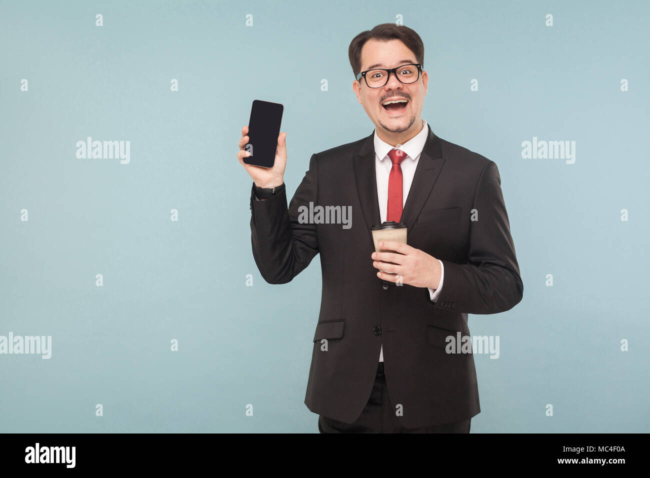 Business, gadgets,technologies. Man showing new phone. Indoor, studio ...