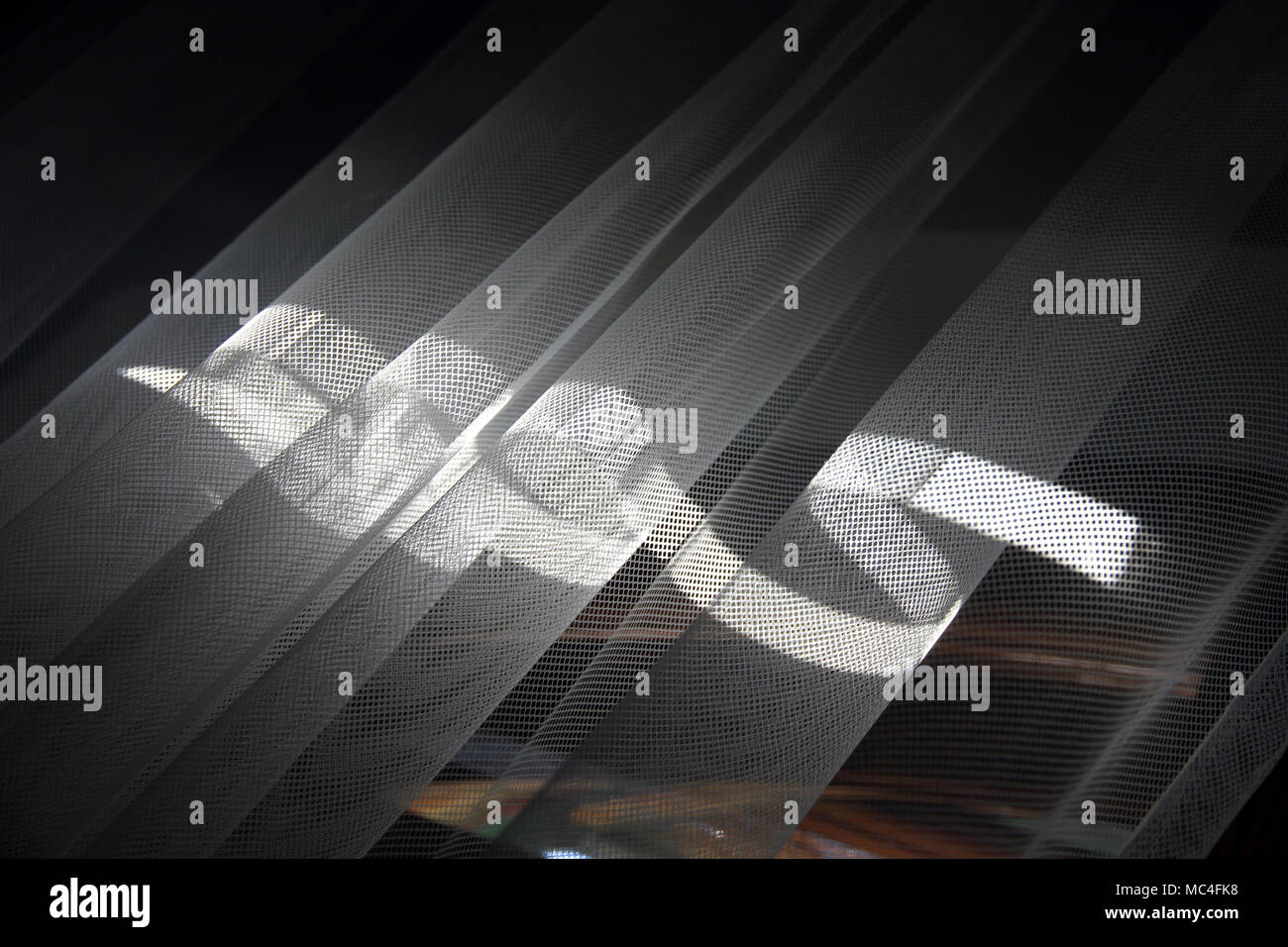 light beam on net curtain Stock Photo - Alamy