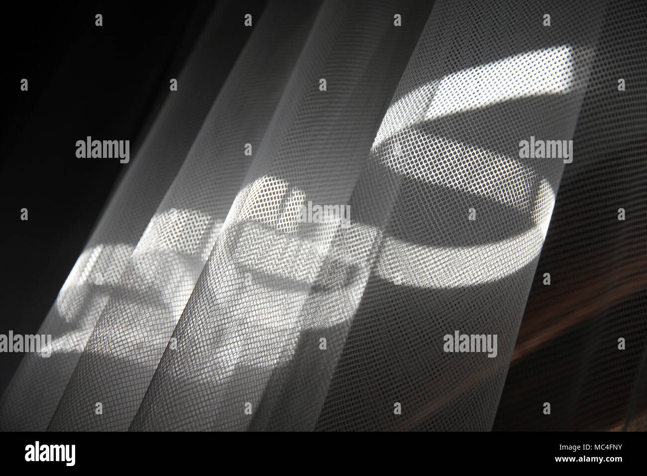 light beam on net curtain Stock Photo - Alamy