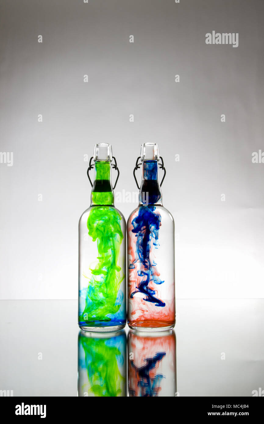 Two bottles with color smoke Stock Photo - Alamy