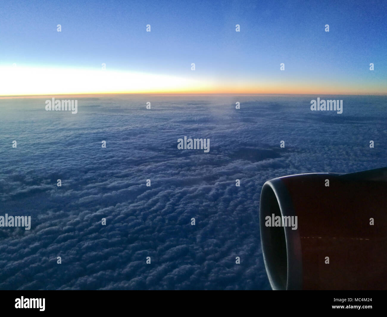 Sun rise from above the cloud from window seat of airplane Stock Photo ...