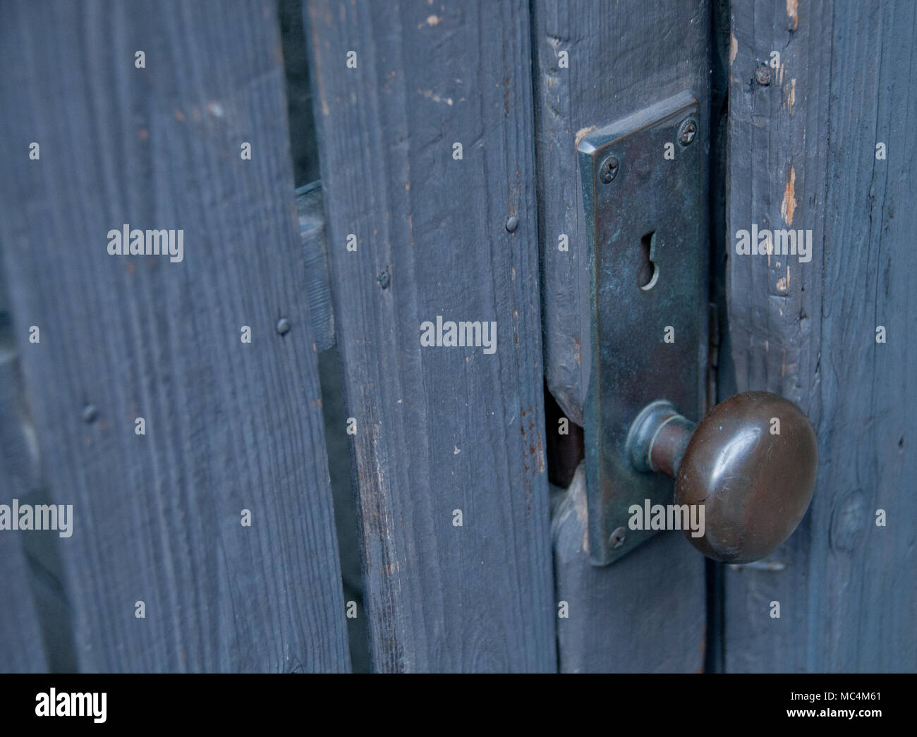 Round classic metal lock with key hold on wooden door Stock Photo - Alamy