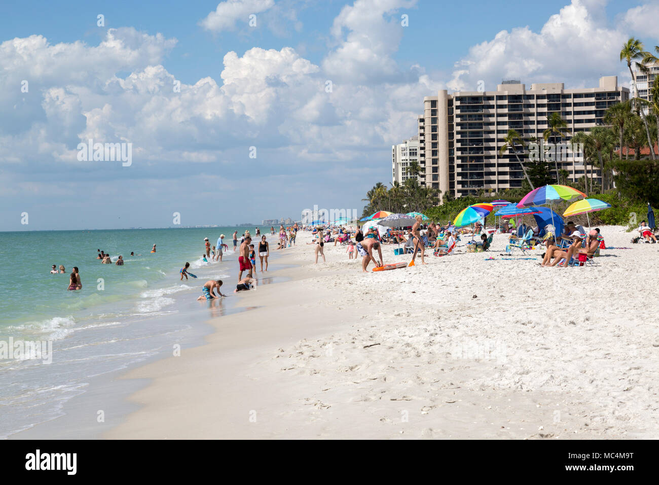 Vacationers in Naples, Florida enjoying beach activities. Sunbathing ...