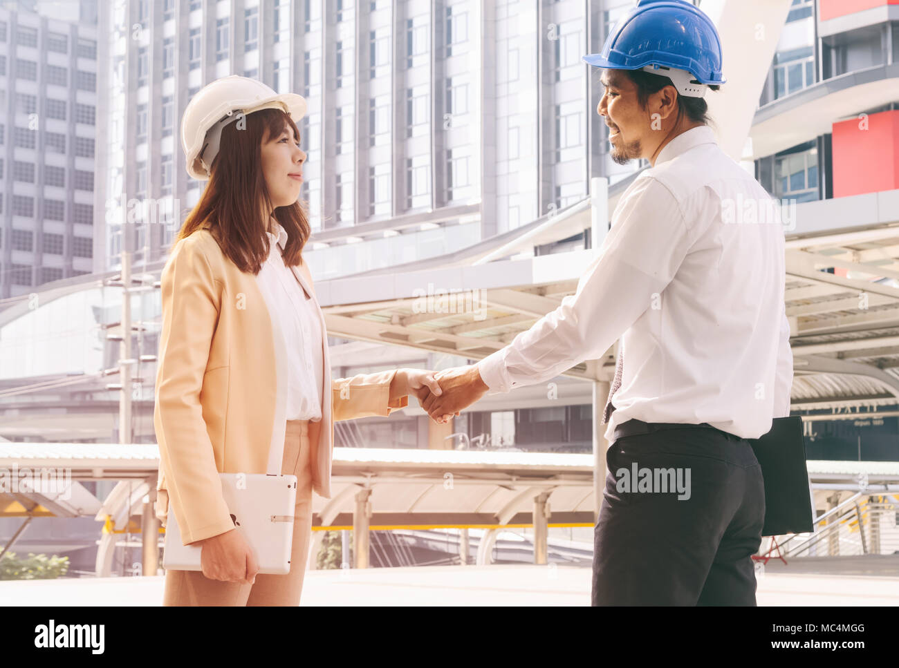 Chief Engineer shaking hands with construction worker in the ...