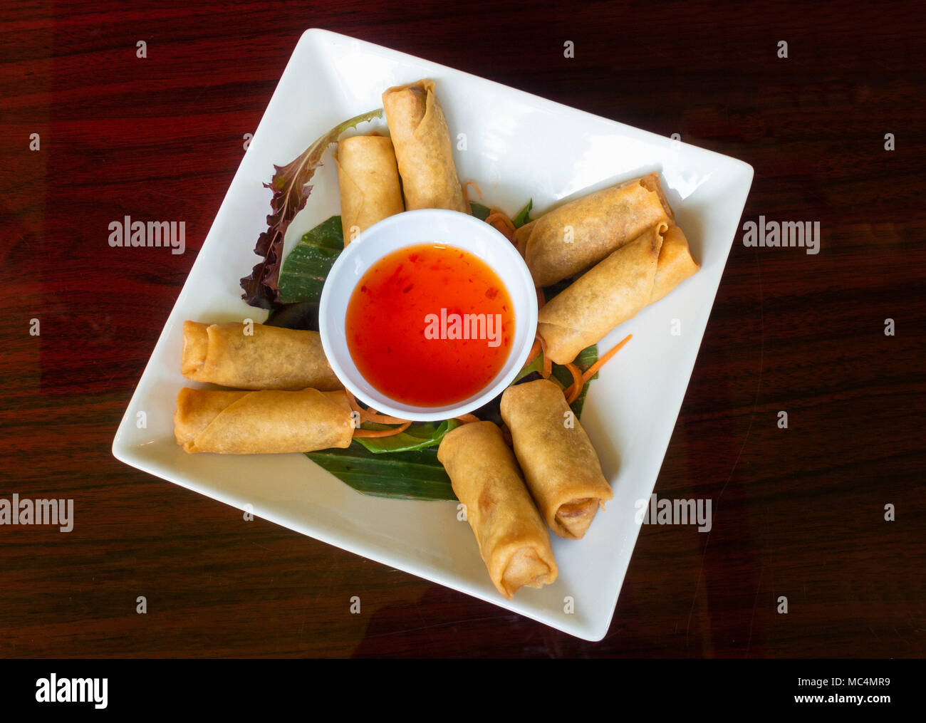 Thai spring rolls with a spicy dipping sauce Stock Photo - Alamy