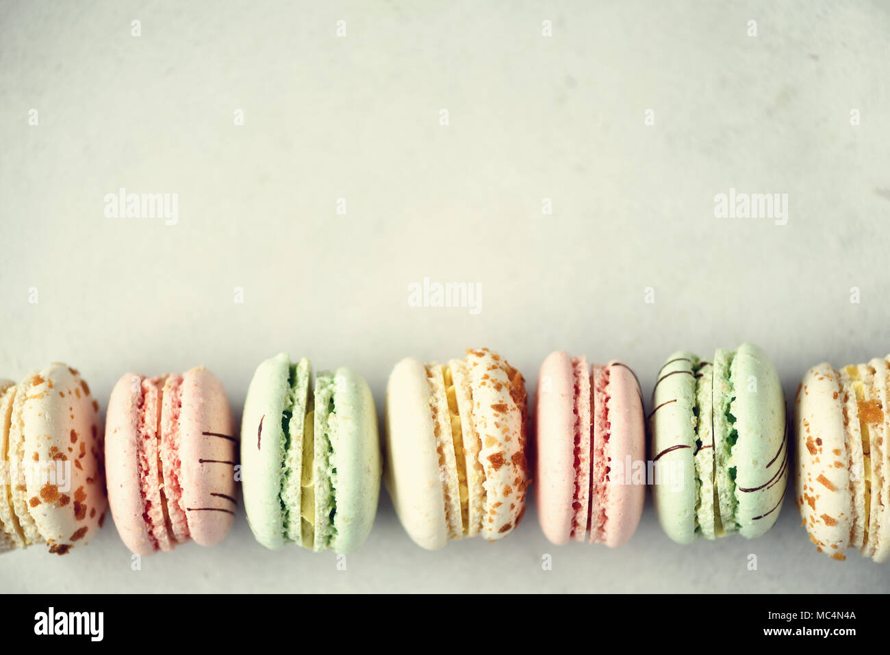 Colorful french macaroons flat lay. Pastel colors pink, green, yellow ...
