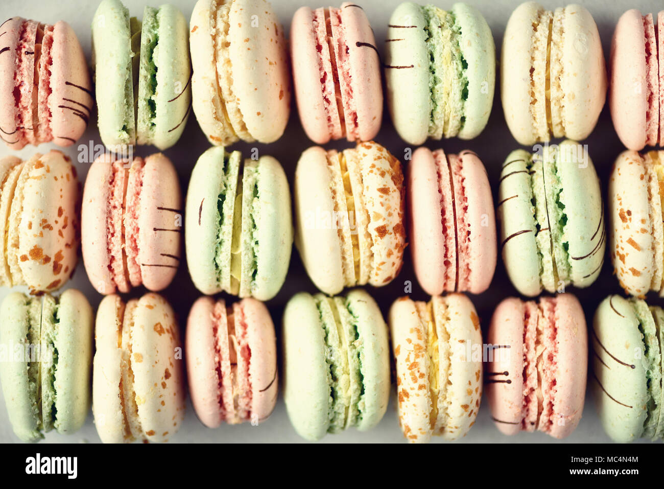 Colorful french macaroons flat lay. Pastel colors pink, green, yellow ...