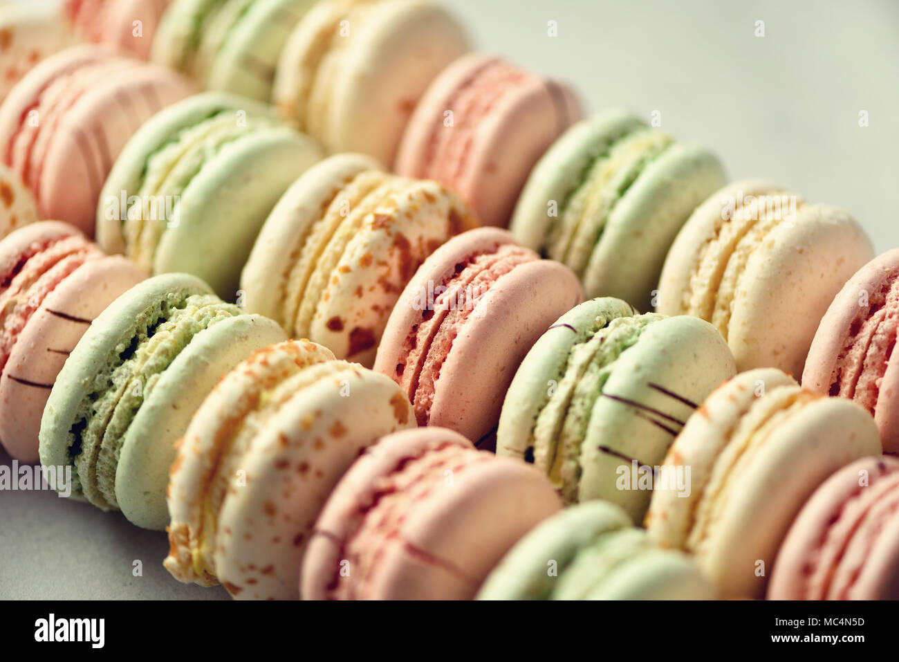 Colorful french macaroons flat lay. Pastel colors pink, green, yellow ...