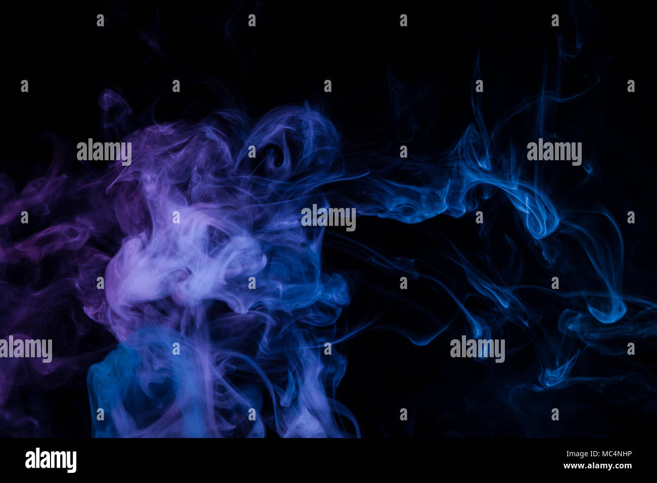 Colorful blue smoke on a black isolated background. Background from the ...