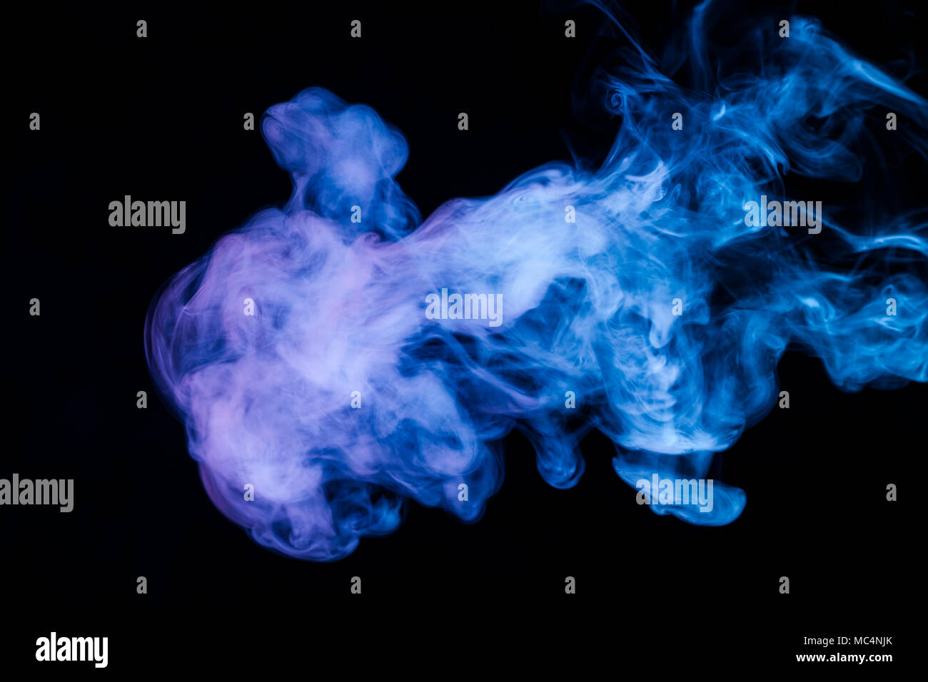 Colorful blue smoke on a black isolated background. Background from the ...