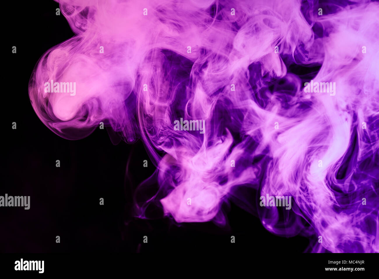 Thick pink colorful smoke on a black isolated background. Background ...