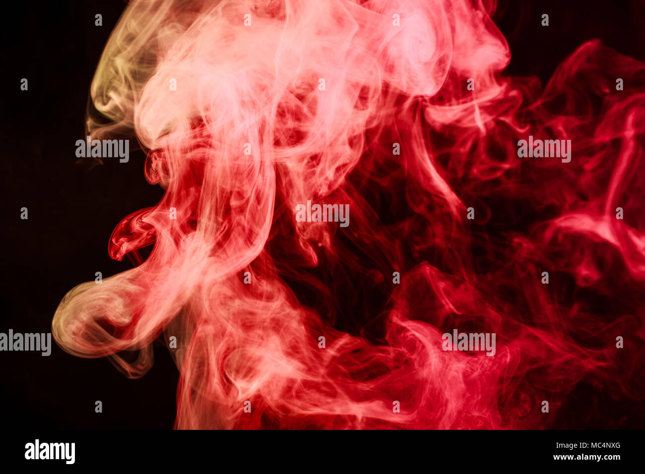 Red cloud of smoke of black isolated background. Background from the ...