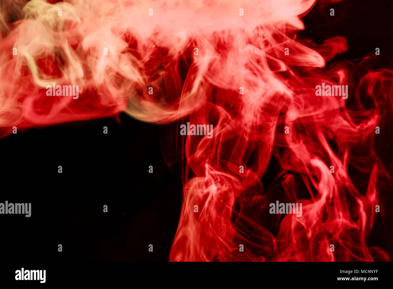 Red cloud of smoke of black isolated background. Background from the ...
