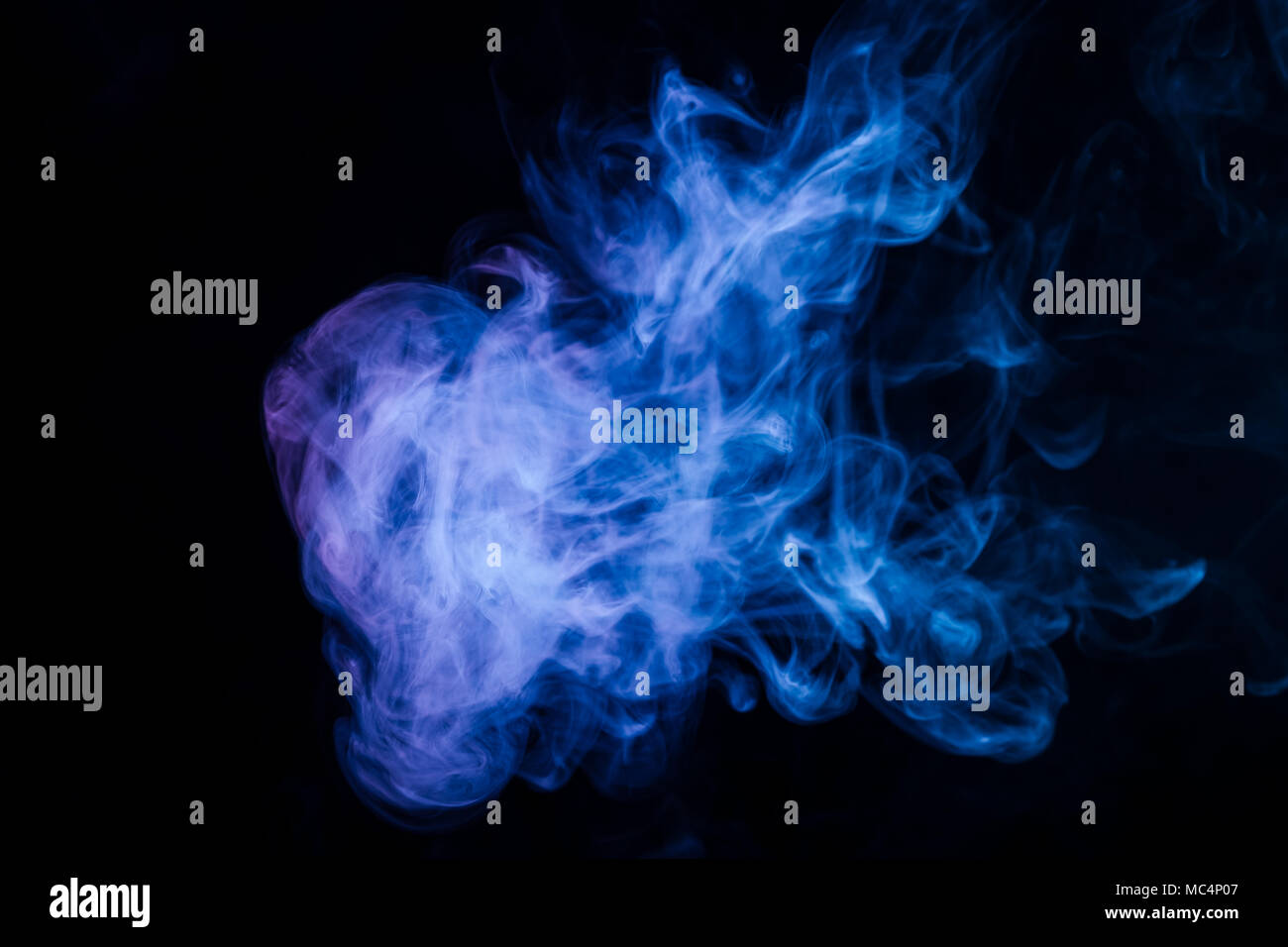 Colorful blue smoke on a black isolated background. Background from the ...