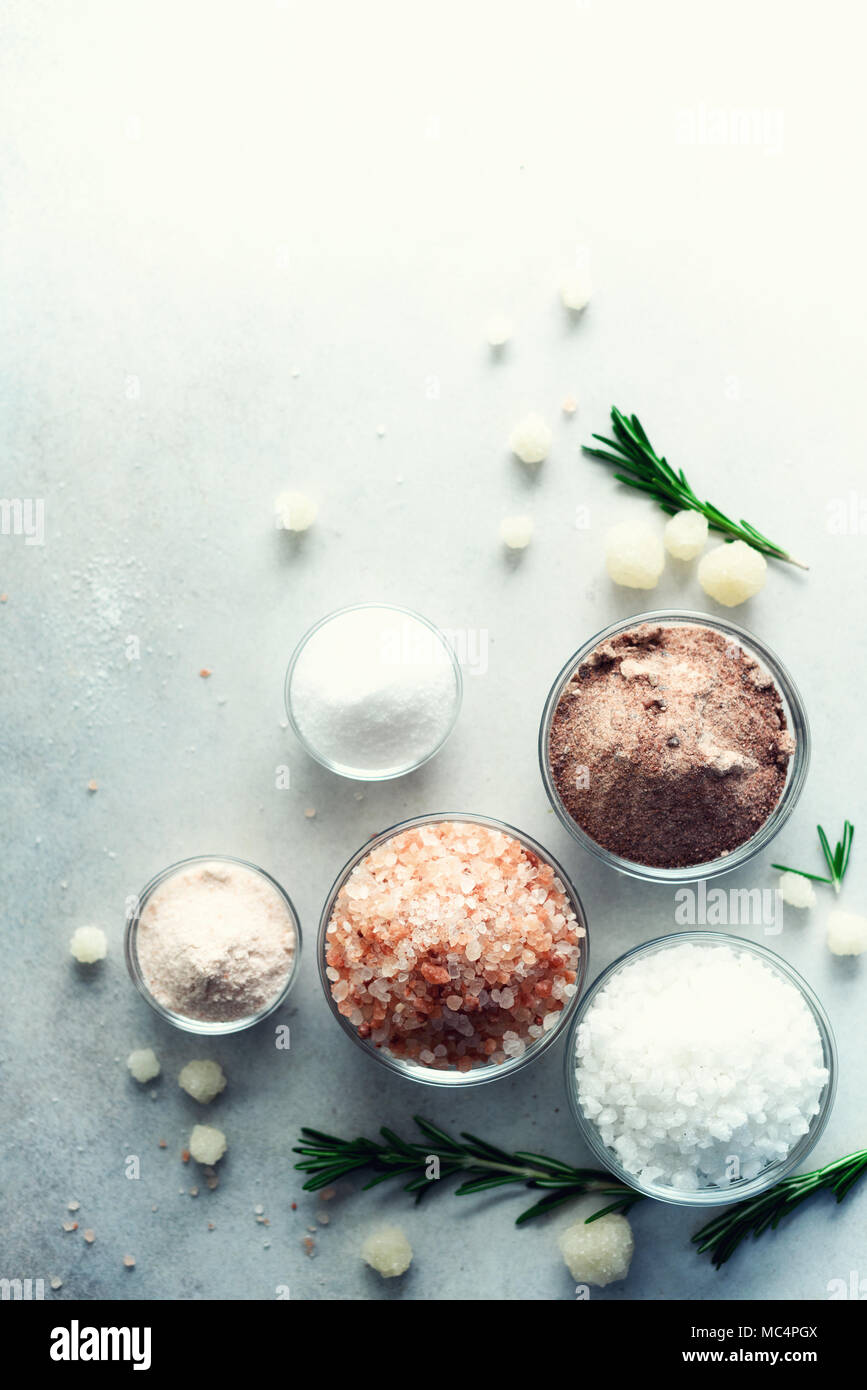 Mix of different salt types on grey concrete background. Sea salts ...