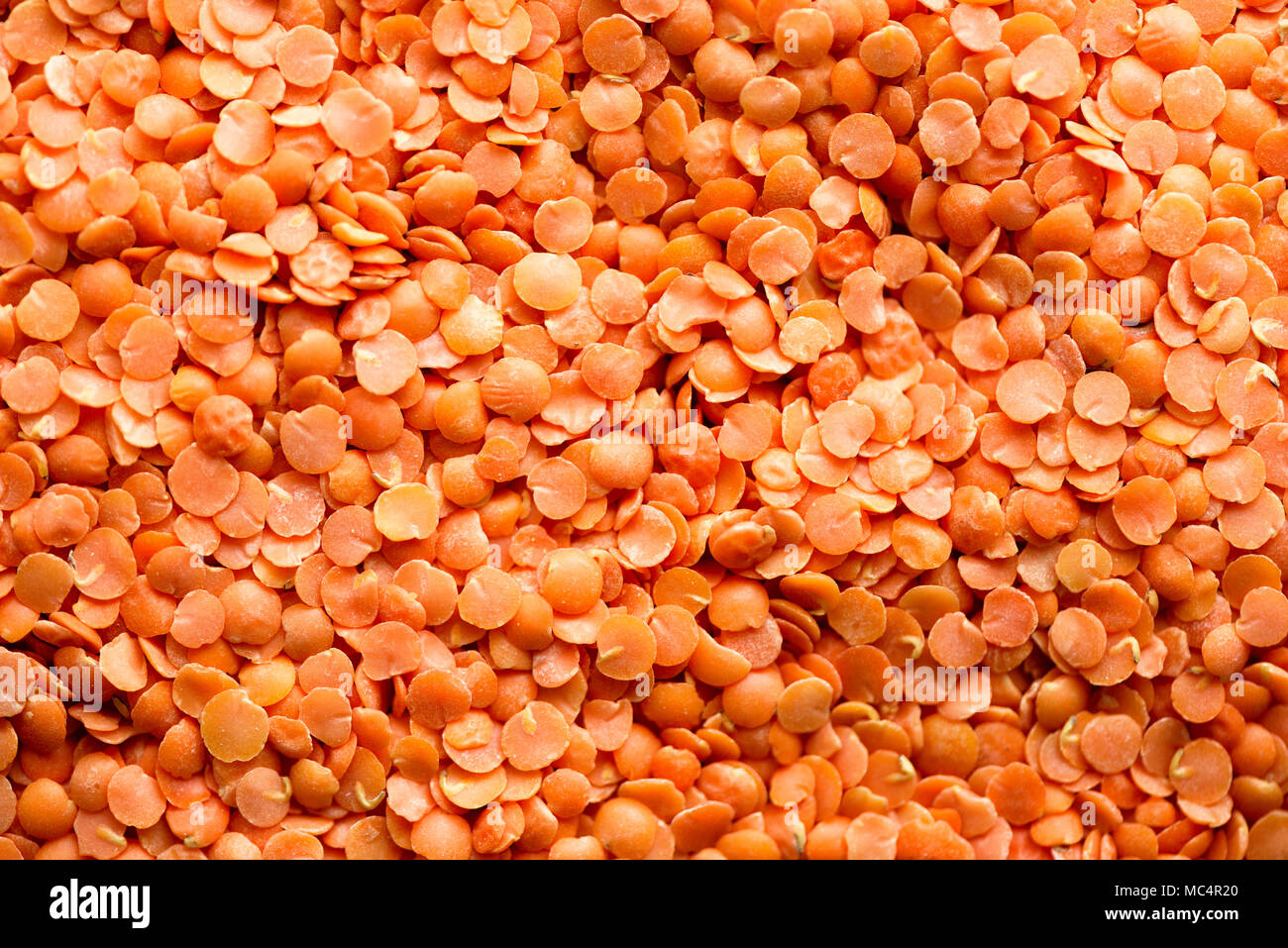 Red raw organic lentils texture. Food ingredient background. Top view ...