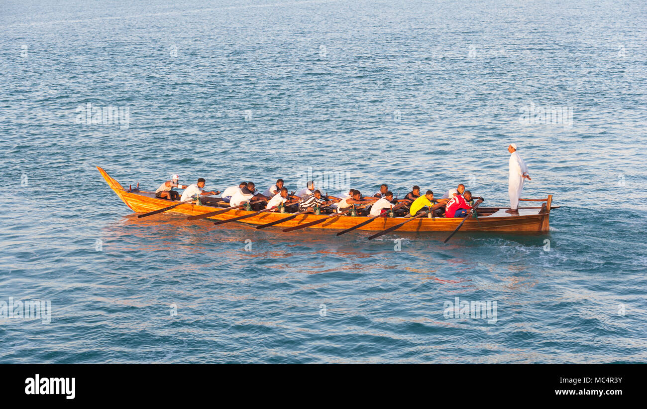 Arab Oarsmen rowing a traditional rowing dhow off Abu Dhabi in the ...