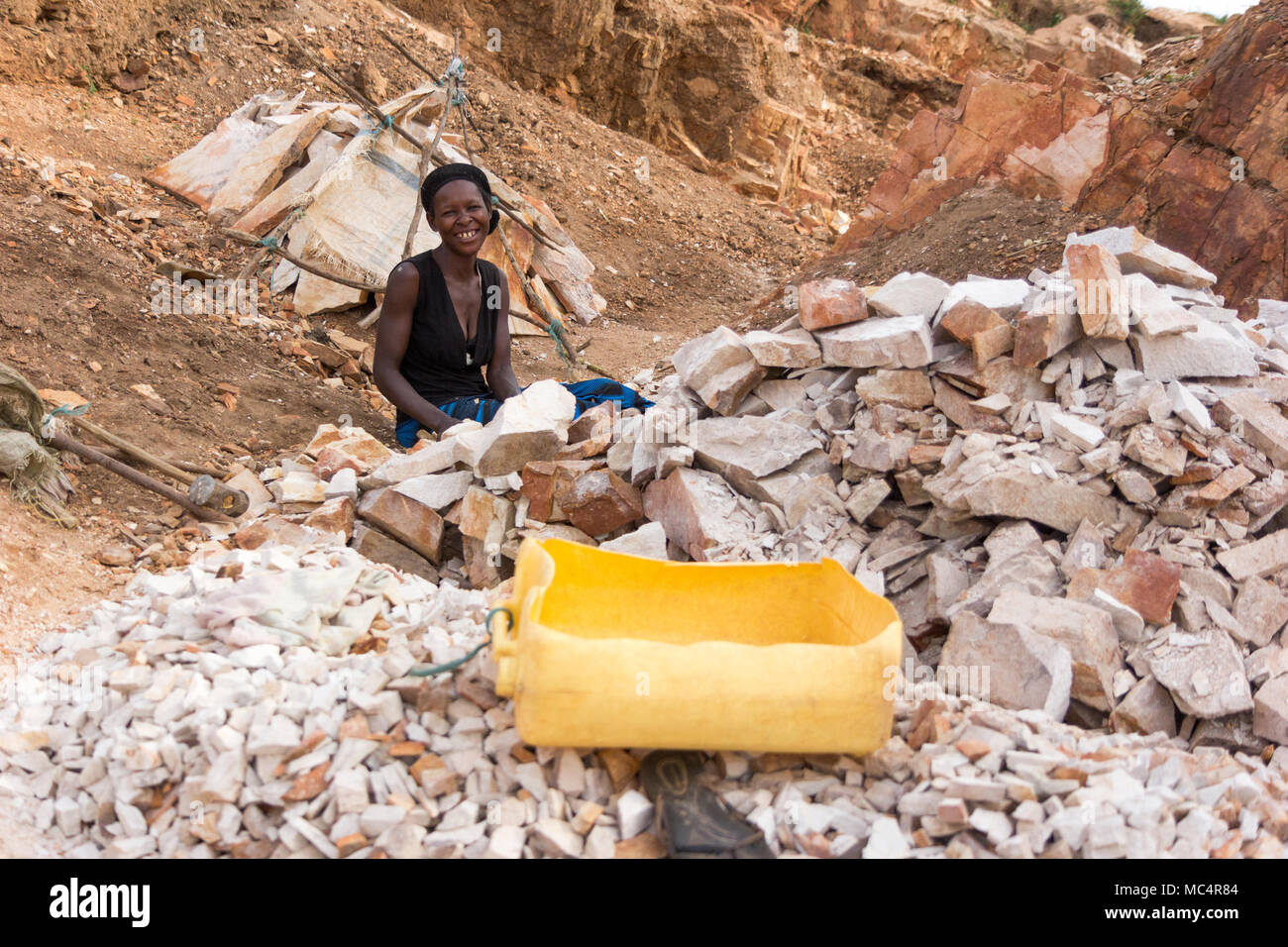 Lugazi, Uganda. June 18 2017. A Ugandan woman breaking rocks into small ...