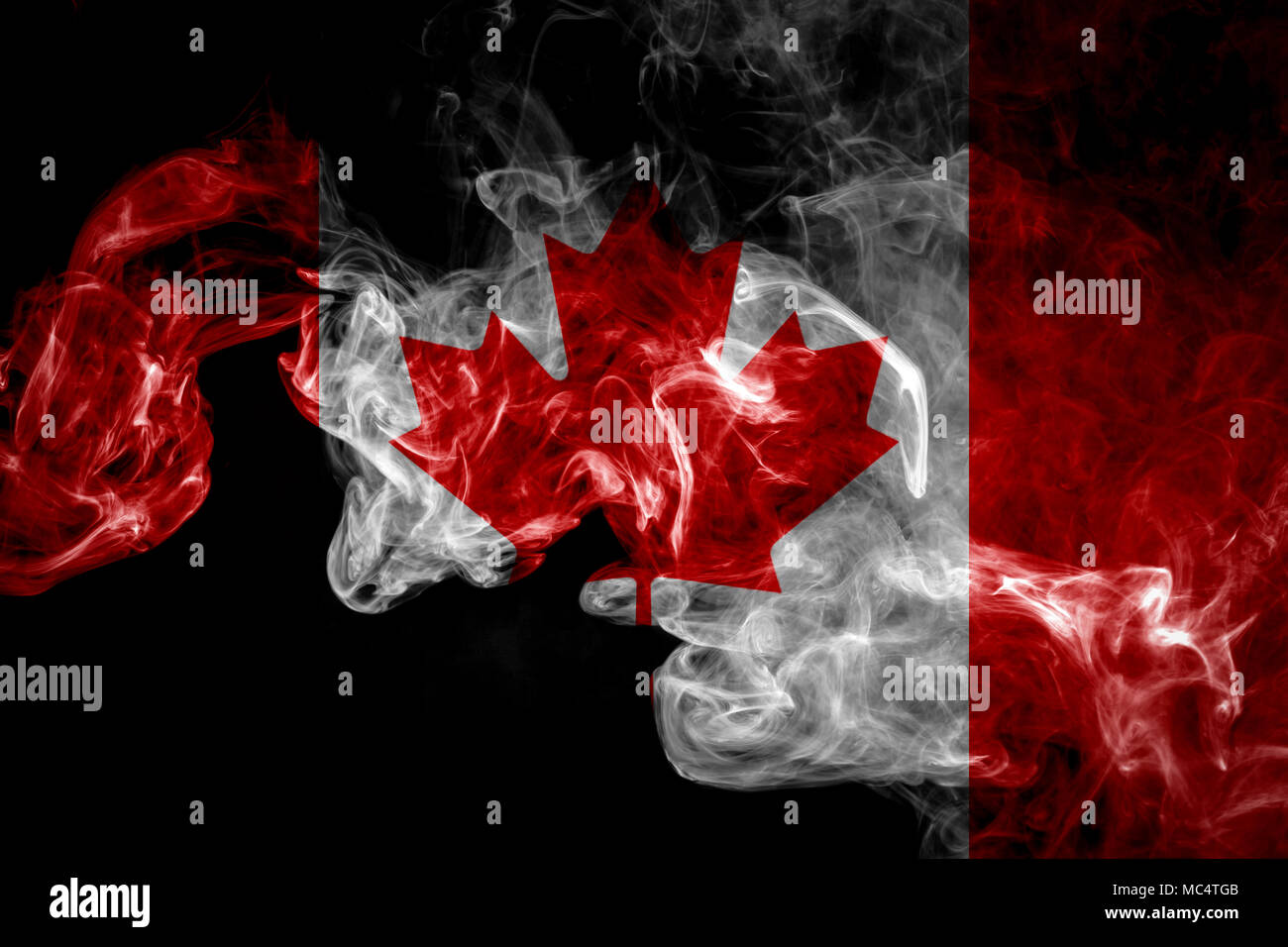 National Flag Canada from thick colored smoke on a black isolated ...