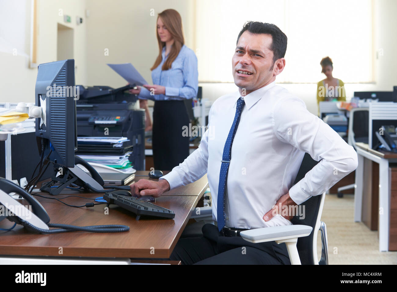 Man sitting back desk office not woman hi-res stock photography and ...