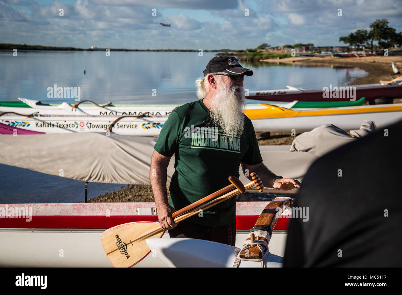 Coach and steersman of the Ka Mamala Hoe Canoe Club demonstrates proper ...
