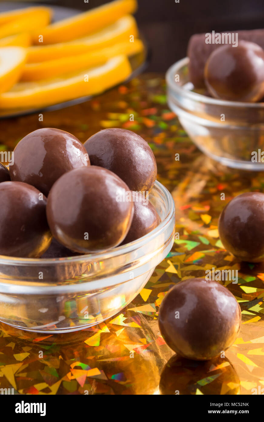 Round candy chocolate close-up on a colorful background with blur and a ...
