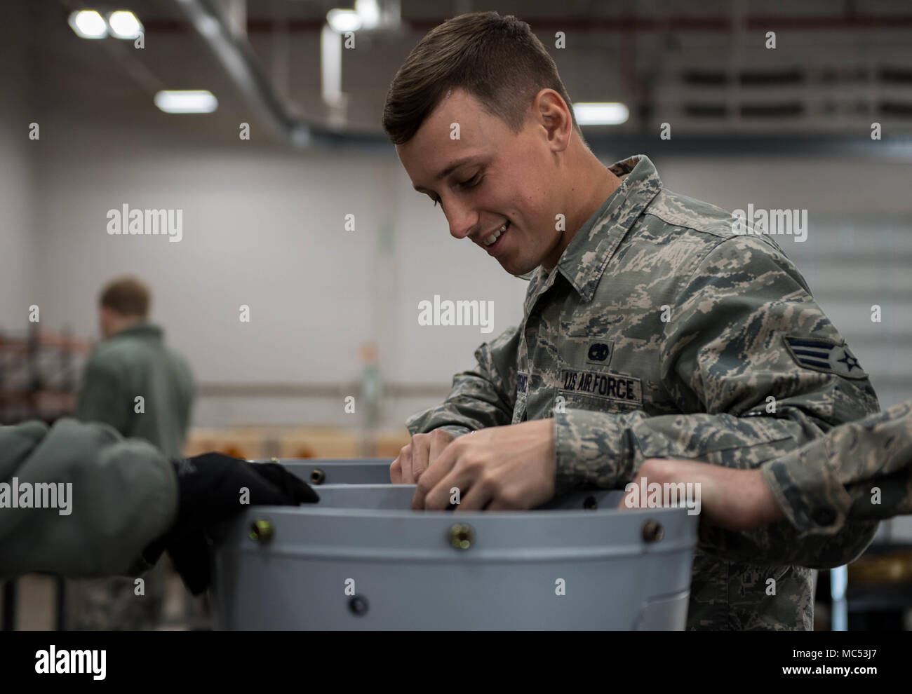 Senior Airman William Lawrence, 2nd Munitions Squadron conventional munitions crew chief, screws ...