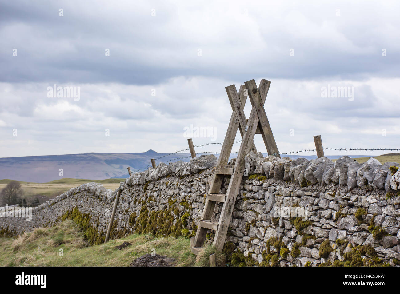 Wooden ladder and stone wall on top of the hill. British countryside ...