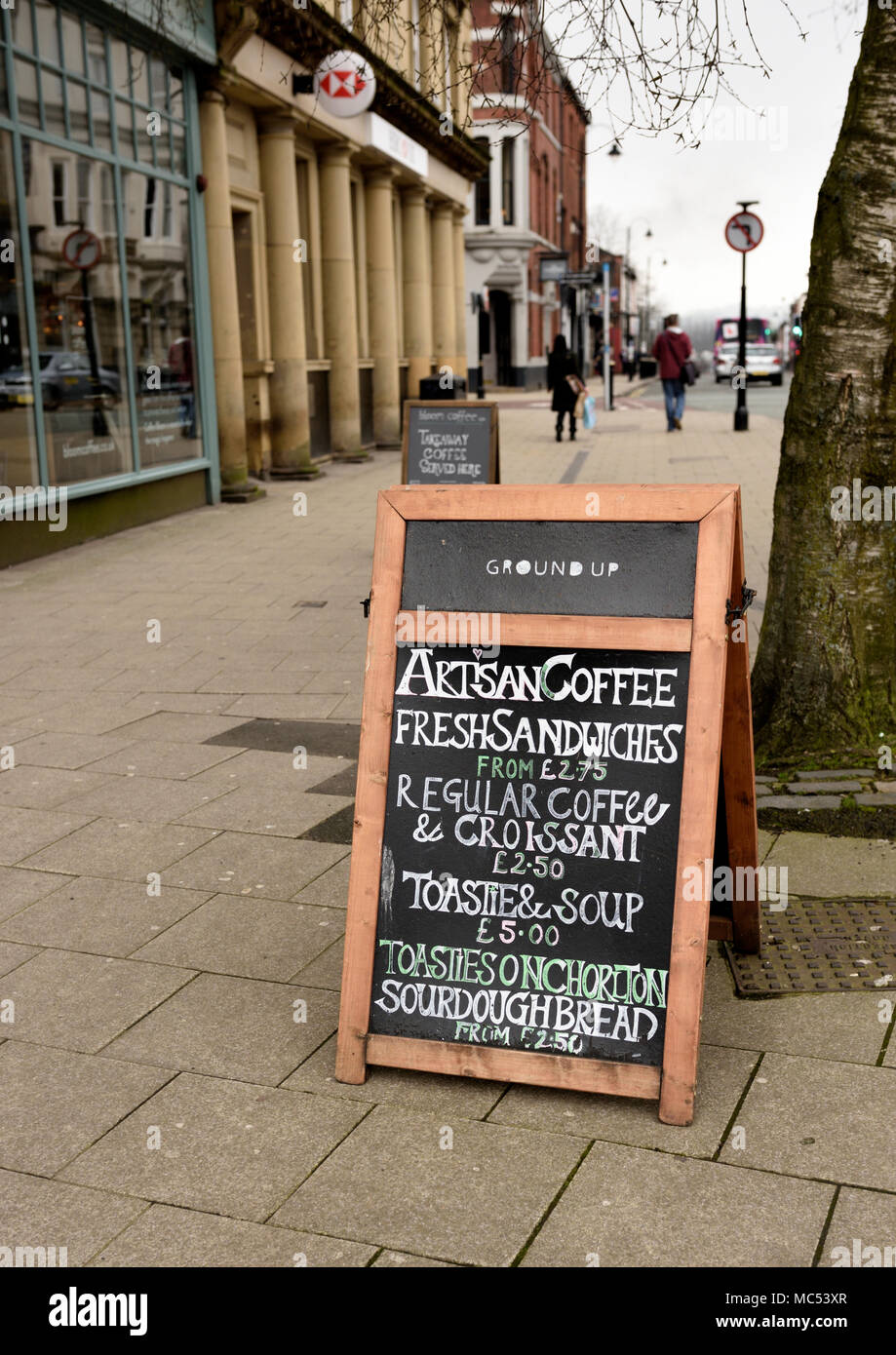 Wooden chalkboard sign, pavement A board advertising artisan coffee and ...