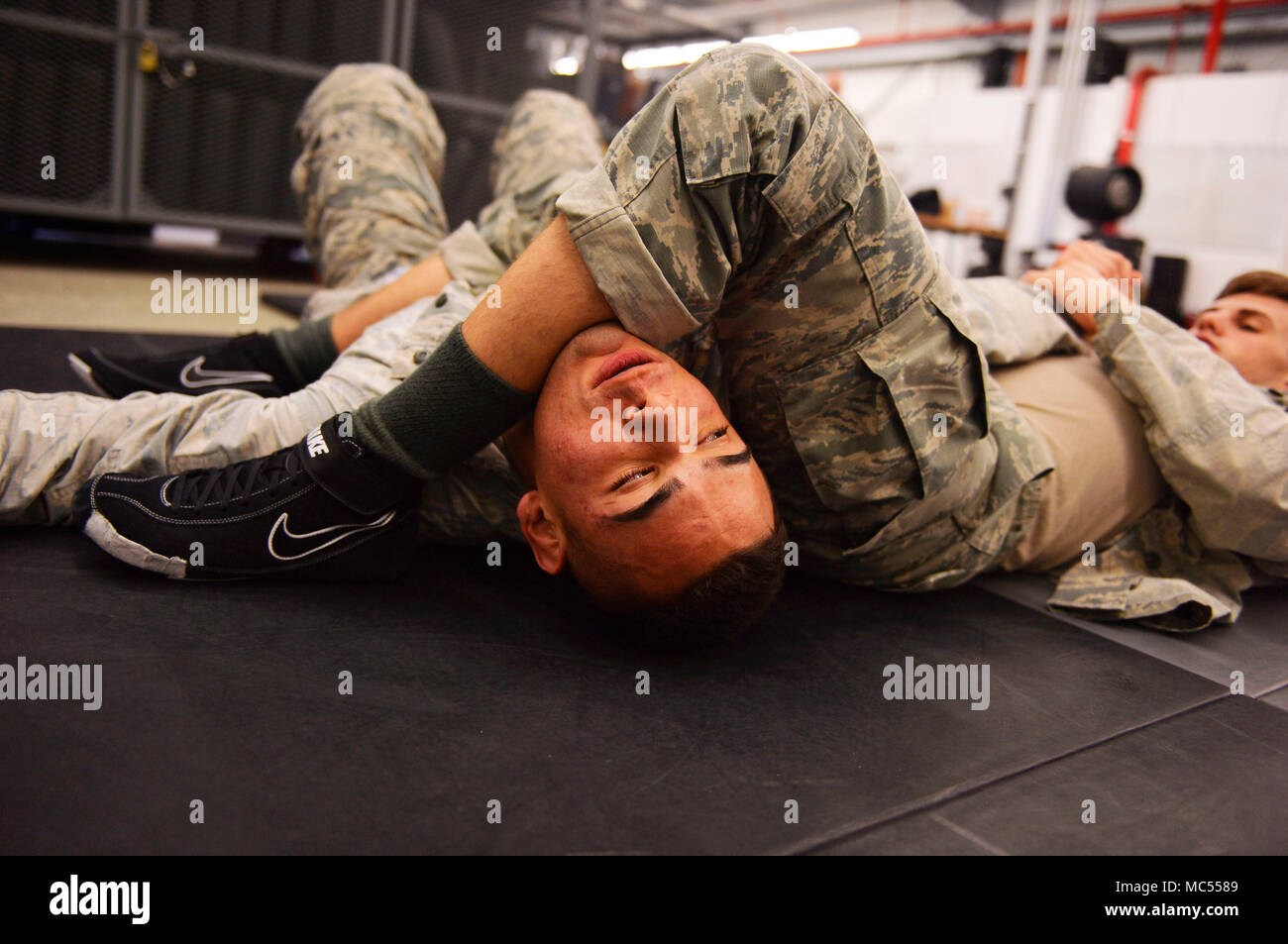 Security forces Airmen participate in a combatives class during a ...