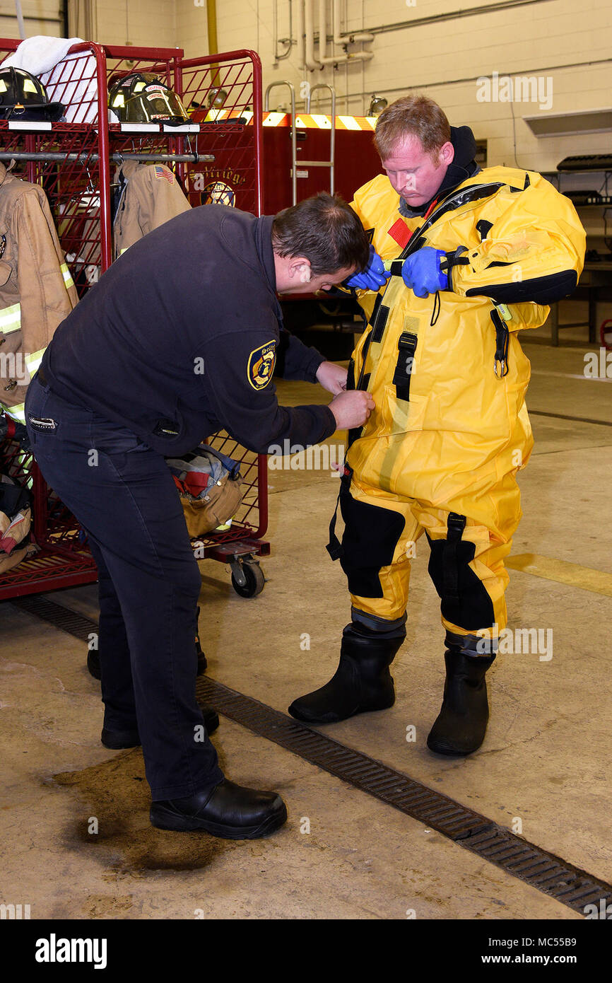 Gary Stringer helps Ed Hirth, both firefighters with the 127th Civil ...