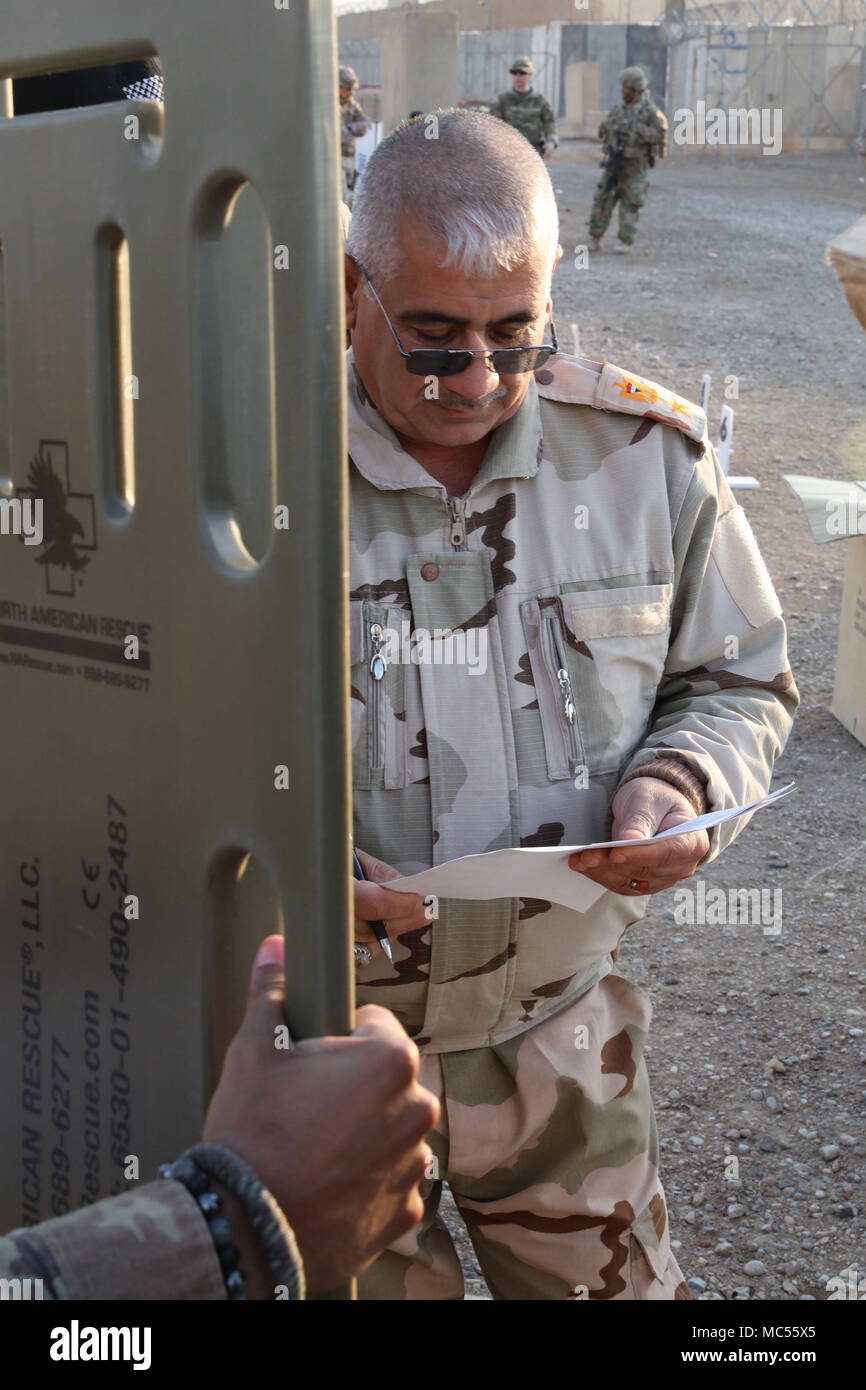 An Iraqi army officer looks at paperwork for spineboards to be received ...